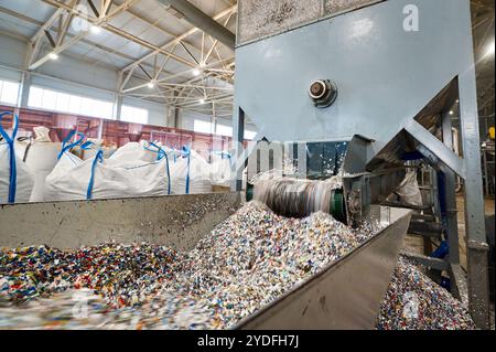 Chopped waste plastic transported by production line Stock Photo - Alamy