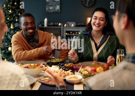 Man having christmas dinner with champagne and watching tv at home ...