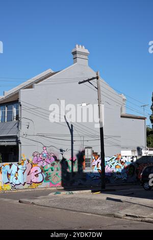 Buildings and streetscape along Enmore Road, in inner city Sydney signs ...