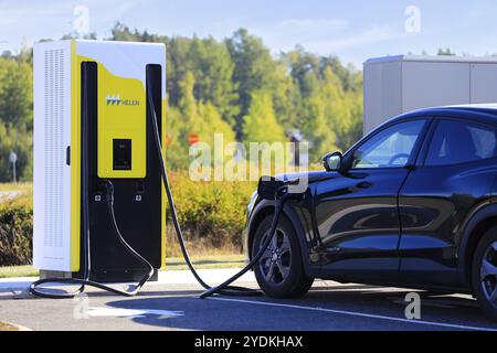 Recharging Ford Mustang Mach-E with the plug in the car socket close up ...