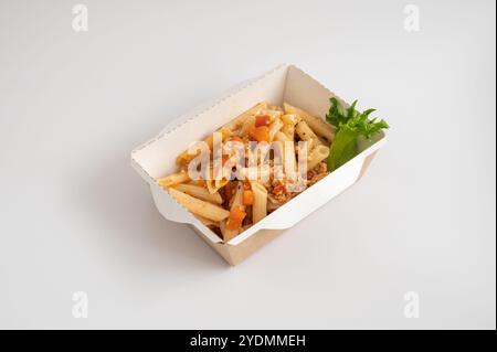 Four takeout meals served in biodegradable containers, featuring pasta ...