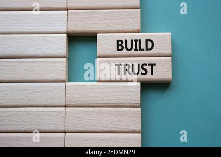Build trust symbol. Wooden blocks with words Build trust. Beautiful ...