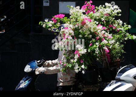 A motorcycle rides through a street in the Balat neighborhood of the ...