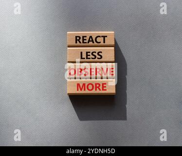 React less Observe more symbol. Wooden blocks with words React less ...