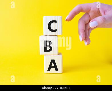 CBA - Cost Benefit Analysis symbol. Wooden cubes with word CBA ...