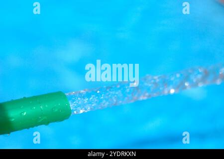 Rubber hose splashing water Stock Photo - Alamy