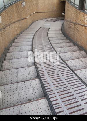 Staircase with ramp leading to underground passage Stock Photo - Alamy
