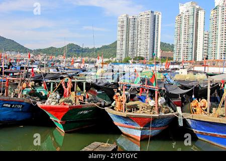 Fishing vessels anchor at a harbor to avoid approaching Typhoon Trami ...