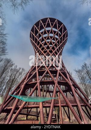 A striking spiral-shaped wooden observation tower set against a clear ...