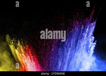 Freeze motion of colorful painted powder exploding on dark background ...