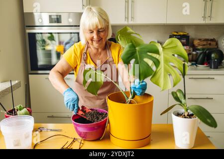A person wearing a protective glove pours organic waste, including ...