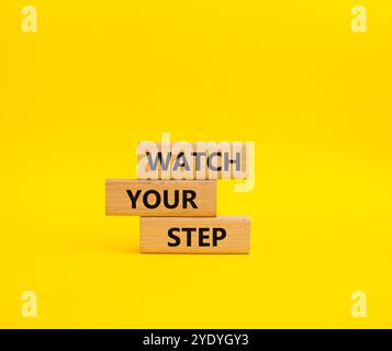 Watch your Step symbol. Concept words Watch your Step on wooden blocks ...