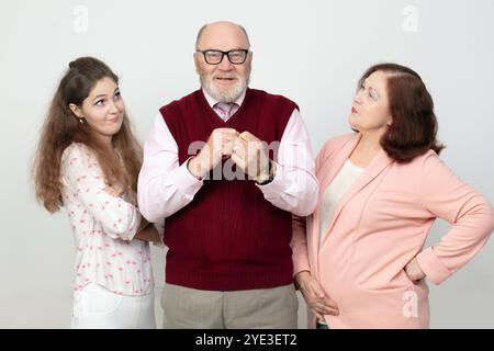 A photo of a father being looked at reproachfully by an adult daughter ...