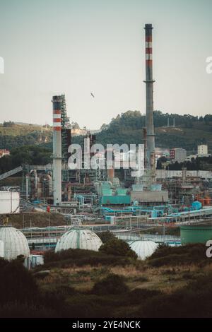 Industrial plant with smokestacks and metal structures, representing ...