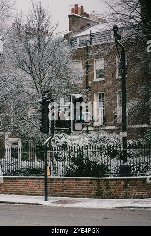 London street with brick houses under snowfall in winter Stock Photo ...