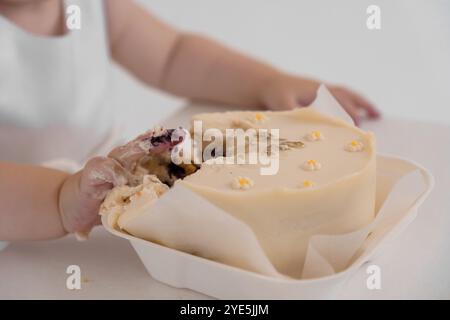 Adorable Baby Hand Reaching for a Deliciously Messy Birthday Cake Stock ...