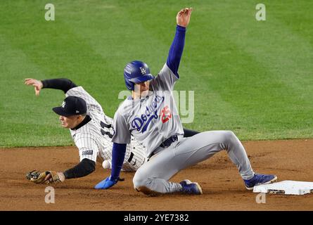 New York Yankees shortstop Anthony Volpe, center, reacts while interacting with center fielder ...