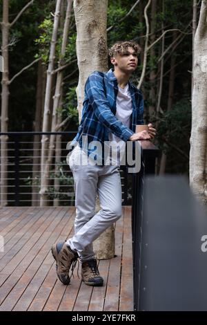 Young Man in Casual Outfit Stands Confidently Against a Bright Yellow ...