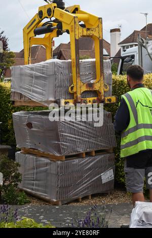 Order load of brick blocks deliver by lorry uploading Stock Photo - Alamy