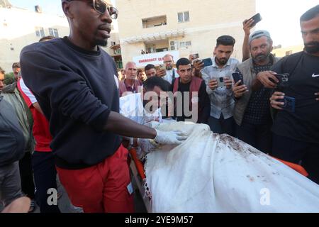 A Palestine Red Cresent Society member mourns over the body of his ...