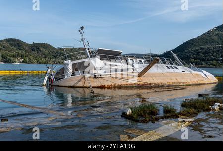 A half submerged sunken boat in shallow water Stock Photo - Alamy