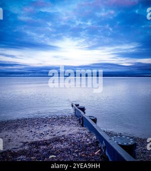 First light of dawn, breaking through thick cloud cover, shinning down ...