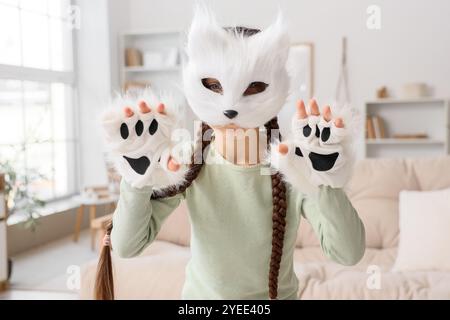 Quadrober girl in cat mask on carpet at home Stock Photo - Alamy