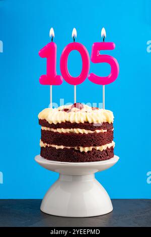 Birthday cake with number 105 candle - Red velvet on a fuchsia ...
