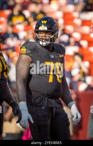 Washington Commanders offensive tackle Cornelius Lucas watches during ...