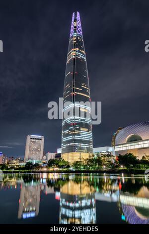 Modern building is reflected in lake in city Park. Summer Sunny day in ...