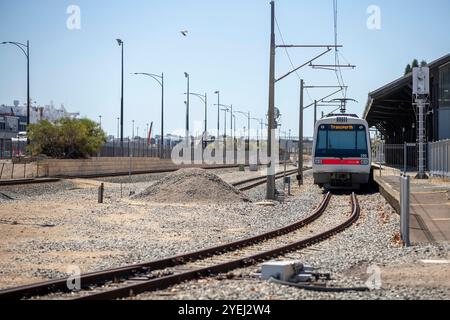 A Transperth train stopped at a railway station under sunny conditions ...