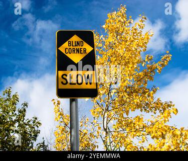 Slow down blind corner sign and symbol Stock Photo - Alamy