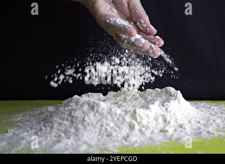 Baker throwing bread dough in bakery Stock Photo - Alamy
