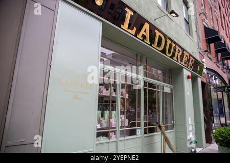 This photograph shows the exterior of a Ladurée storefront, featuring ...