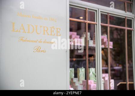 This photograph shows the exterior of a Ladurée storefront, featuring ...