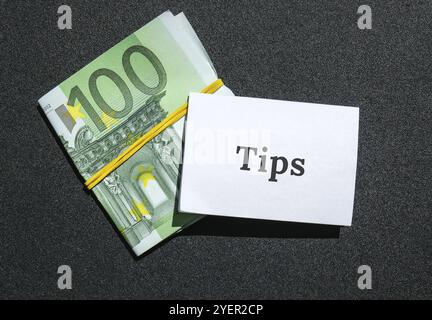 Euro bills, savings ins, money. Paper note written word TIPS. Business ...