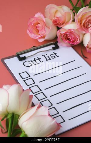 GIFT LIST on paper note. Delicate pink roses on pink background ...