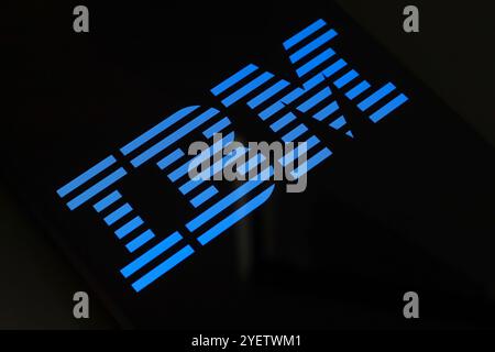 In this photo illustration an IBM logo seen displayed on a smartphone ...