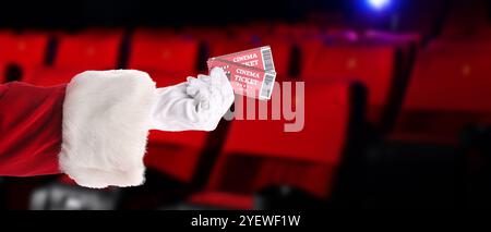 Santa with tickets in cinema. Christmas movie concept Stock Photo - Alamy