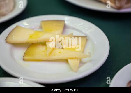 Tasting of Spanish cheeses, triangles of manchego curado cheese on ...