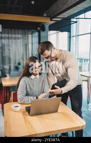 Colleagues share their experience working in the office at a laptop ...