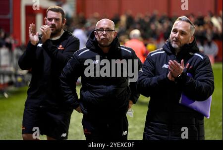 Tamworth manager Andy Peaks (centre left) celebrates with players and ...