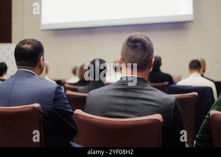Listening to a presentation in a conference hall while standing Stock ...