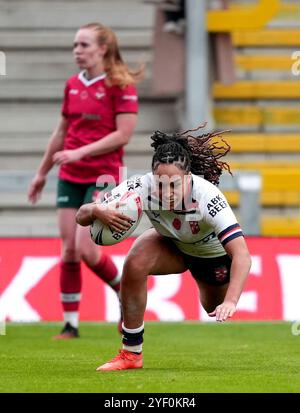 England's Amelia Brown goes over to score a try against Wales, during ...