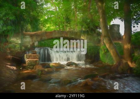 An arched waterfall and stone bridge at Slitting Mill, Rugeley, England ...