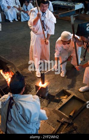 Traditional Japanese sword makers hammering red hot iron in the ...