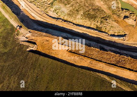 Excavator removing overburden for sand mining, aerial view Stock Photo ...