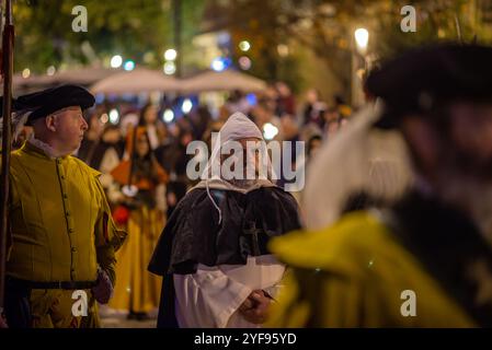 Actor characterized with pale makeup and costumes with flames in night ...