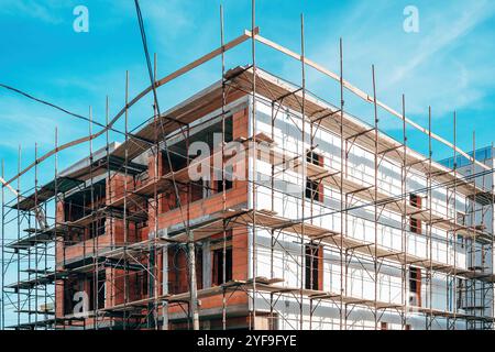Old rusty scaffolding surrounding building structure, selective focus ...
