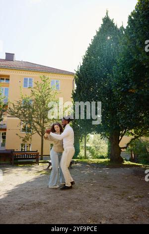 Couple practicing salsa dance in building back yard Stock Photo - Alamy